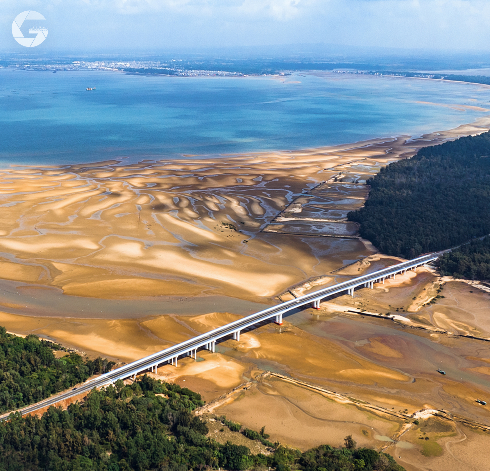 The Hainan Scenic Coastal Highway traverses an estuary in Guangcun ...